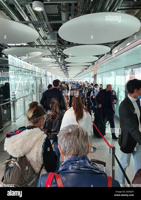 Passengers Queue For The Arrival Hall At London Heathrow Airports Terminal 5 Due To A Problem