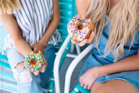 Two Friends With Donuts By Stocksy Contributor Brian Powell