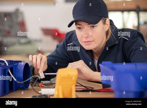 Female Technician Wiring Cables Into Chocolate Box Stock Photo Alamy