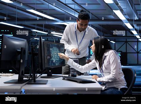 Team Of Technicians Doing Maintenance On Server Hub To Optimize It For Data Processing