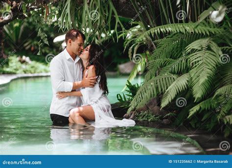 Happy Couple Kissing While Relaxing In Outdoor Spa Swimming Pool Stock