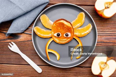 팬케이크 오렌지 접시에 사과에서 재미 있은 게 얼굴 모양 간식 귀여운 아이 아이 아이들의 달콤한 디저트 건강 한 아침 점심 나무 배경에 음식 예술 상위 뷰 건강한 식생활에