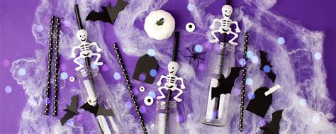 할로윈 장식 흰색 호박 박쥐 눈 보라색 배경에 칵테일에 대한 소름 빨대를 가진 병 장식 할로윈 파티 개념 플랫 레이 상단 보기