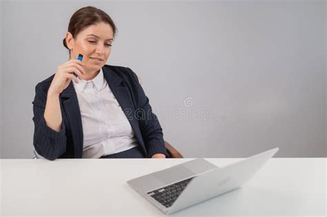 Business Woman Smoking A Disposable Vape While Sitting At Her Desk