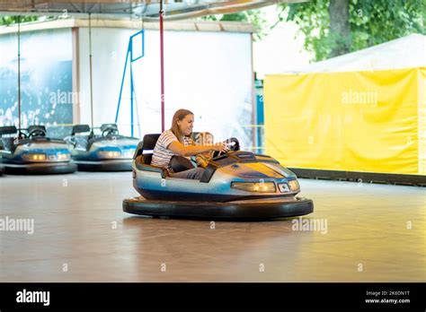 Mother And Son Having Ride In The Bumper Car At The Amusement Park