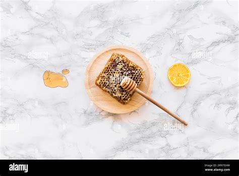 Honey Dipper With Honeycomb Lemon Slice White Marble Background Stock