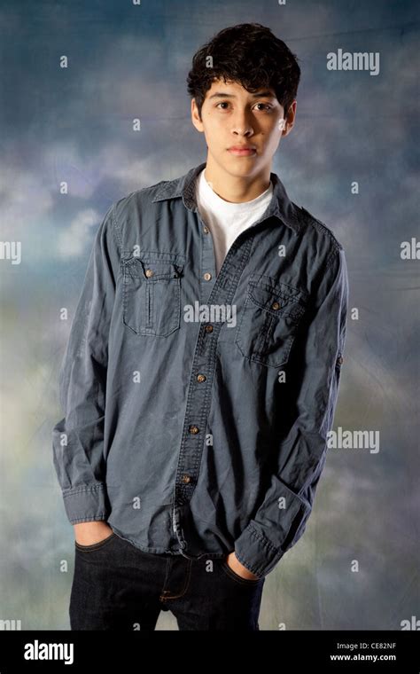 Handsome Latino Boy Standing With His Hands In His Pants Pockets And A