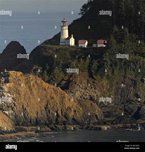 Heceta Head Lighthouse On The Oregon Coast Sits Atop Sheer Cliffs And