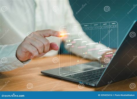 Person Hand Interacts With A Digital Gantt Chart Displayed On A Laptop