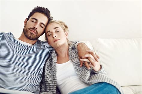 Couple Sleep And Hug Together On Sofa To Relax Rest And Cuddle In