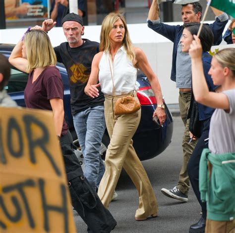 Jennifer Aniston Goes Braless In Low Cut Black Dress While Filming New