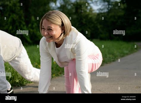 Mature Woman In Start Block Position Stock Photo Alamy