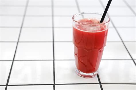 Premium Photo Freshly Squeezed Watermelon Juice In A Glass Cup With Straws On A Background Of