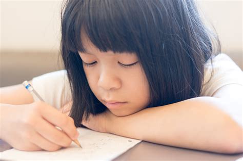 집에서 지루해 느낌과 지루한 숙제를 하 고 아시아 아이 소녀 여성 귀여운 어린이 농축액 종이에 쓰기 아시아 학생 들은 시험에 대 한 수학 과목을 연습 집에서 학생 공부