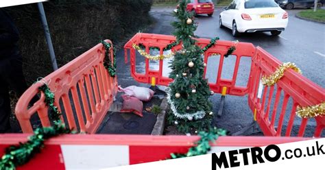 Gaping Hole Left In A Street Decorate For Christmas By Fed Up Local