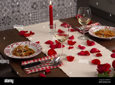Dinner Table Set For Two With White Wine Bolognese Spaghetti And Red