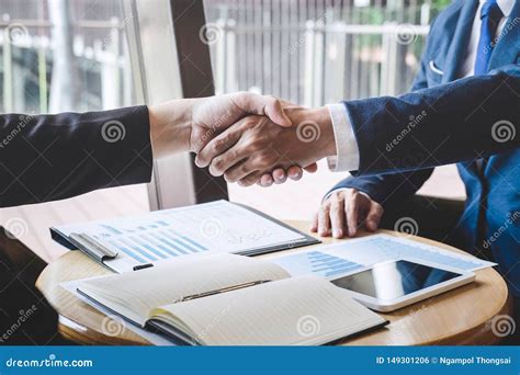 Finishing Up A Meeting Handshake Of Two Happy Business People After Contract Agreement To