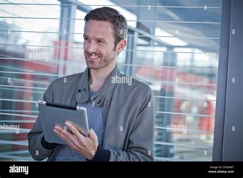 Man With Ipad Outdoors Stock Photo Alamy