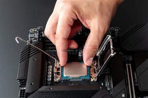 Computer Cpu Installation Hand Of Master Installs Processor Chip On