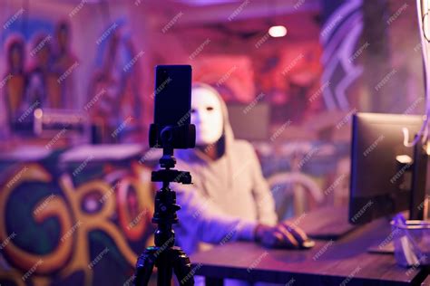Premium Photo Anonymous Criminal Recording Scam On Smartphone Camera In Abandoned Warehouse