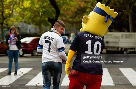 A Real Madrid Fan With A Bart Simpson Mascot Dressed In A Psg Shirt