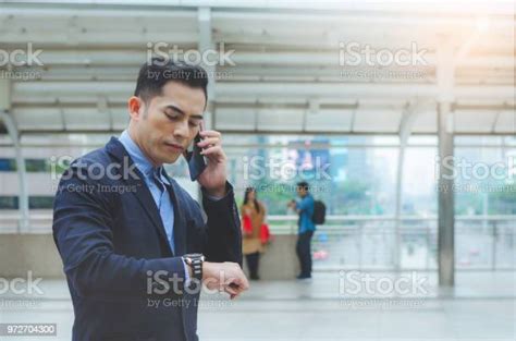 세로 매력적인 잘생긴 사업가 스마트폰 얘기 하 고 작업 시간을 확인 하는 스마트 시계를 찾고 경영자에 대한 스톡 사진 및 기타 이미지 Istock