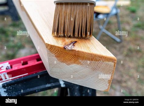 The Woman Impregnates Raw Planed Wooden Pine Beams With Dimensions Of X Mm With A Colorless