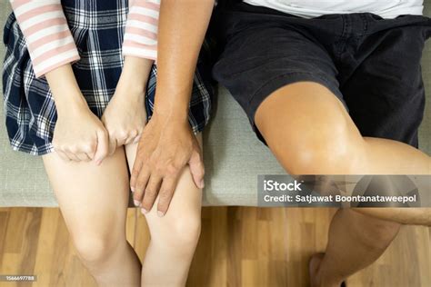 Close Up Hands Of Male Touching Leg Under Short Skirt Of Teenage