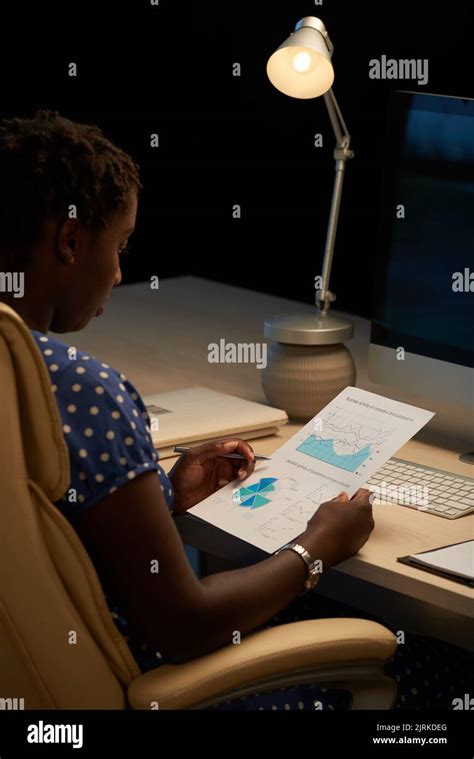 Female Business Executive Analyzing Chart With Financial Data Stock