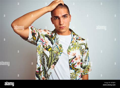 Young Handsome Man On Holidays Wearing Hawaiian Shirt Over White