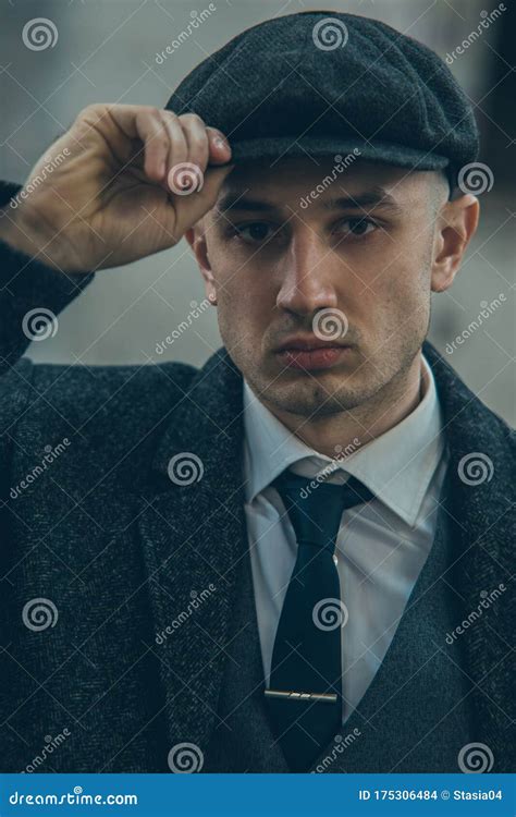 Portrait Of A Man In The Image Of An English Retro Gangster Dressed In