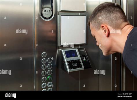 A Man Shows His Face To A Fingerprint Access Control Terminal With A Facial Recognition Function