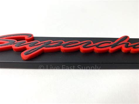 Supercharged In Red On Matte Black License Plate Frame