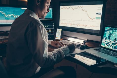 Premium Photo Closeup Male Trader Analyzing Stock Market While Sitting At Office Workstation
