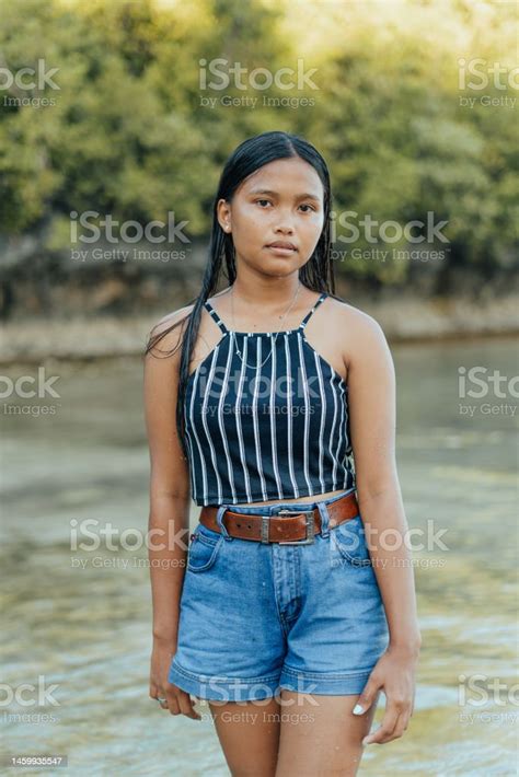 Portrait Of A Beauitful Brown Skin Filipina Model On A White Sand Beach In The Philippines Stock