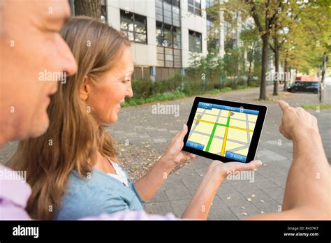 Couple Looking At Gps Map Stock Photo Alamy