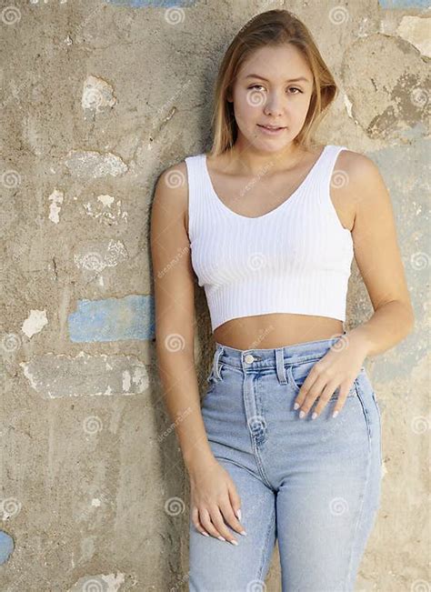 Stunning Young Latina Woman Poses In Denim And Tank Top Stock Image