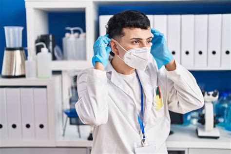 Young Non Binary Man Scientist Wearing Medical Mask At Laboratory Stock