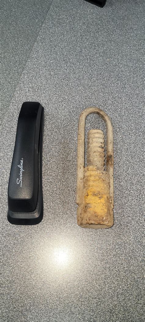 Welded Looking Metal Screw Screwed Into A Spring With A Loop On The