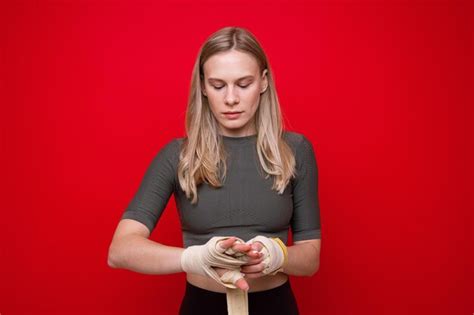Premium Photo Young Athletic Woman Bandages Her Hands Before Boxing