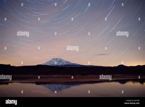 Mount Adams Makes A Perfect Reflection As The Stars Register As Lines In A Long Exposure Stock