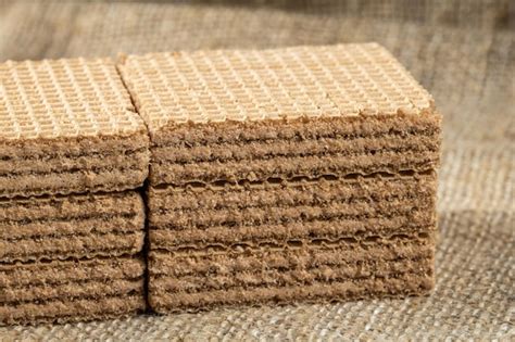 Premium Photo Stack Of Chocolate Wafers On A Burlap Napkin Closeup
