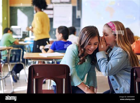 Friends Whisper And Gossip In Classroom For Secret Talking Or