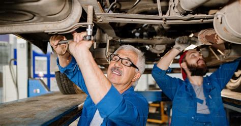 작업복의 성숙한 기술 전문가와 부서진 차를 검사하고 작업장에서 수리하는 그의 젊은 연수생 사진 Unsplash의 자동차 수리 이미지