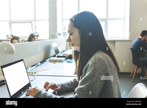 An Adult Girl Uses A Laptop With A Blank White Screen For Mockup Stock Photo Alamy