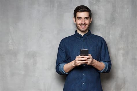 Premium Photo Smiiling Modern Business Man Standing Against Gray