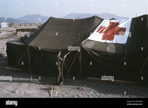A 655th Tactical Field Hospital Squadron Member Marks A Hospital Tent With A Red Cross Roof Sign