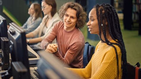 Row Of Computer In University Library Focused Bright Caucasian Babe And Talented Black Girl