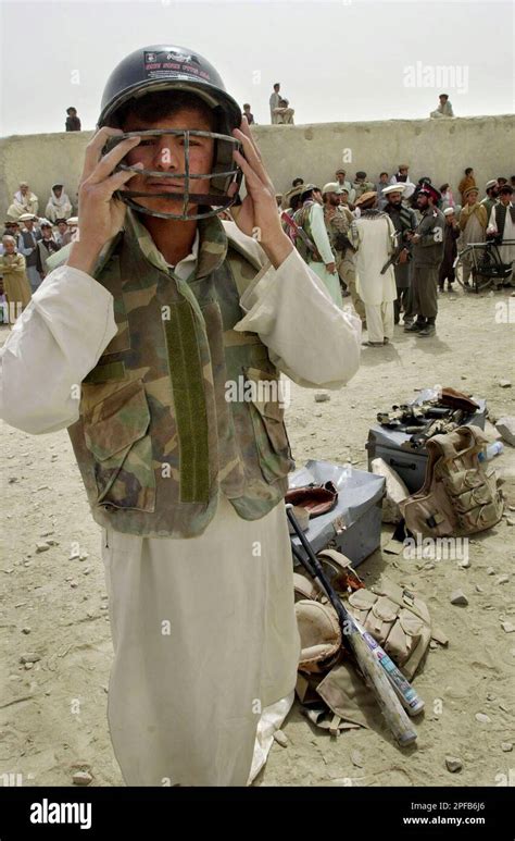 Afghan Catcher Habib Rachmon Of The Afghan Club Puts On His Helmet And