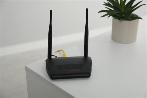 Premium Photo Modern Wifi Router On White Table In Room Space For Text